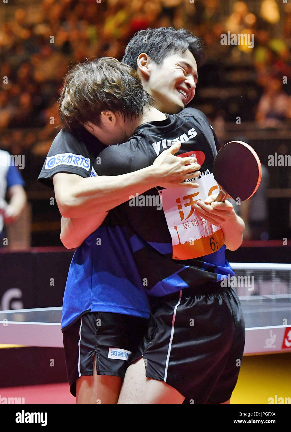 Yuya Oshima (L) and Masataka Morizono of Japan celebrate after reaching the men's doubles final ...