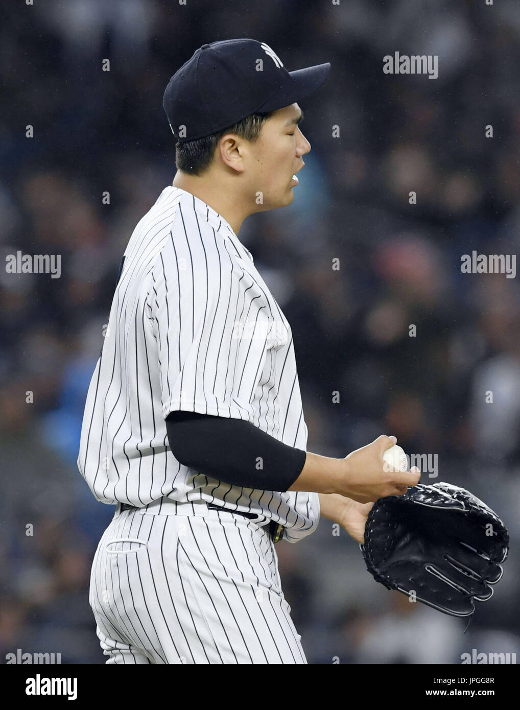 New York Yankees pitcher Masahiro Tanaka reacts after allowing second consecutive homer during ...