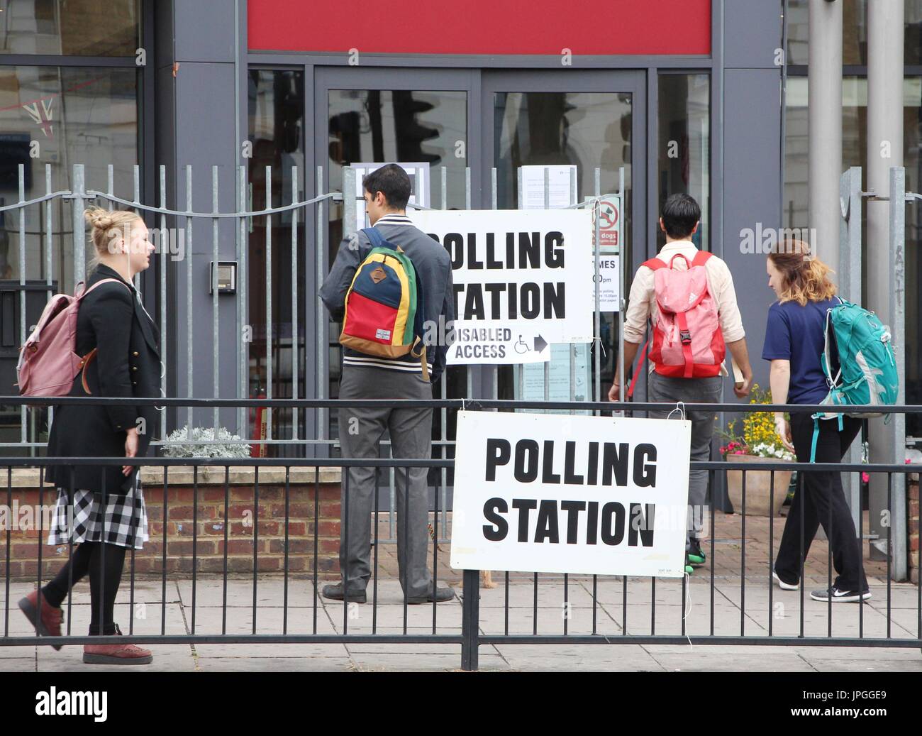 Britons are seen going to polling stations in London on June 8, 2017 ...