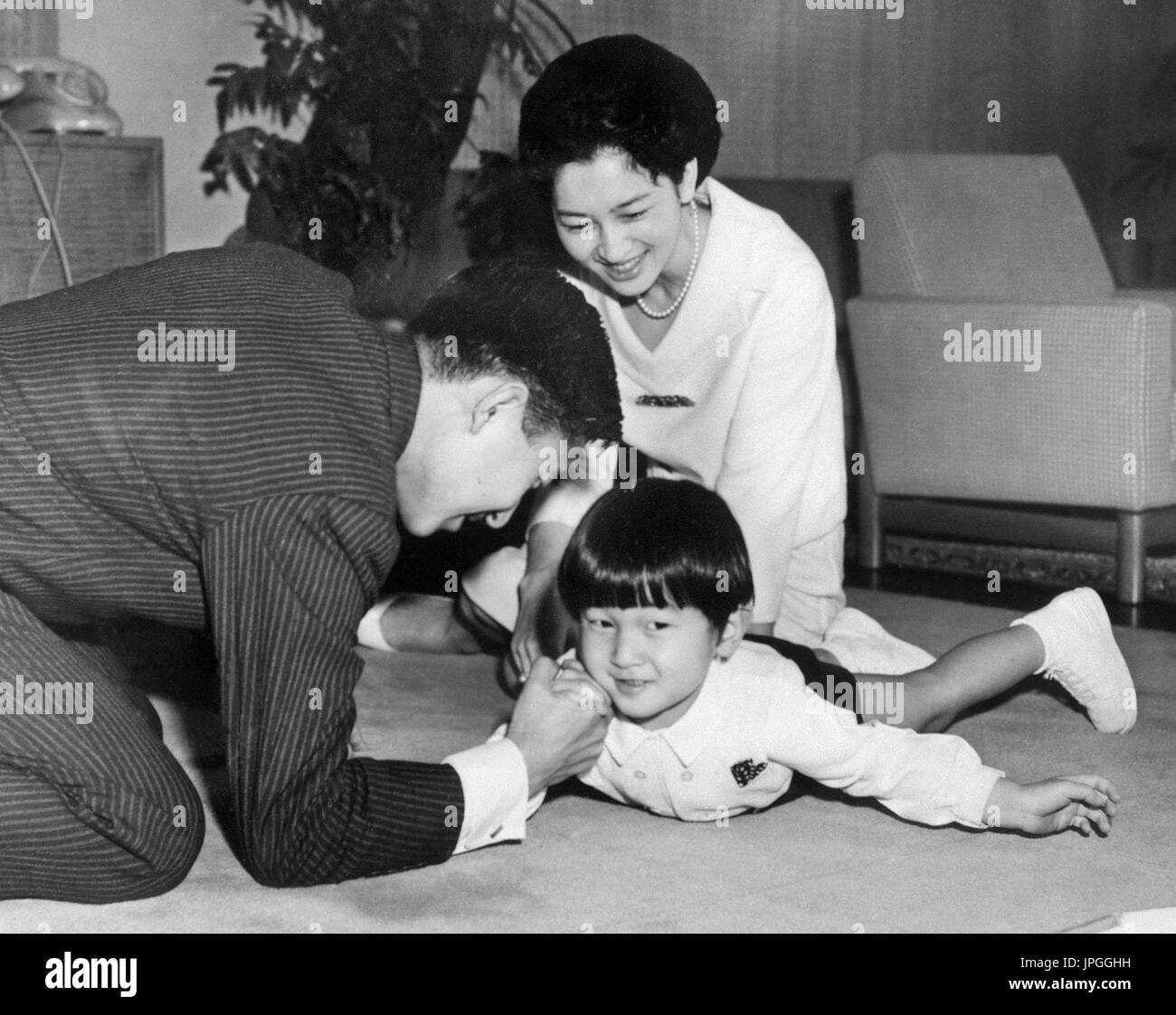 Photo taken in 1964 shows Japan's then Crown Prince Akihito (L) having an arm wrestle with ...