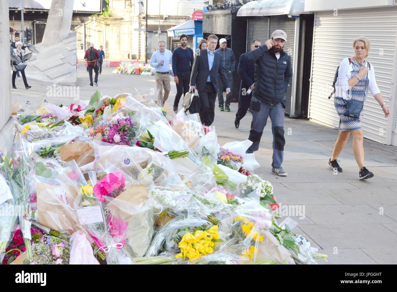 Flowers are placed near the site of a recent terror attack in central ...