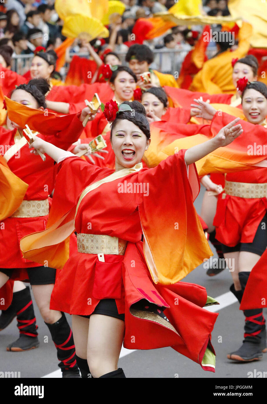 Dancers march through a street in central Sapporo in Hokkaido on June ...