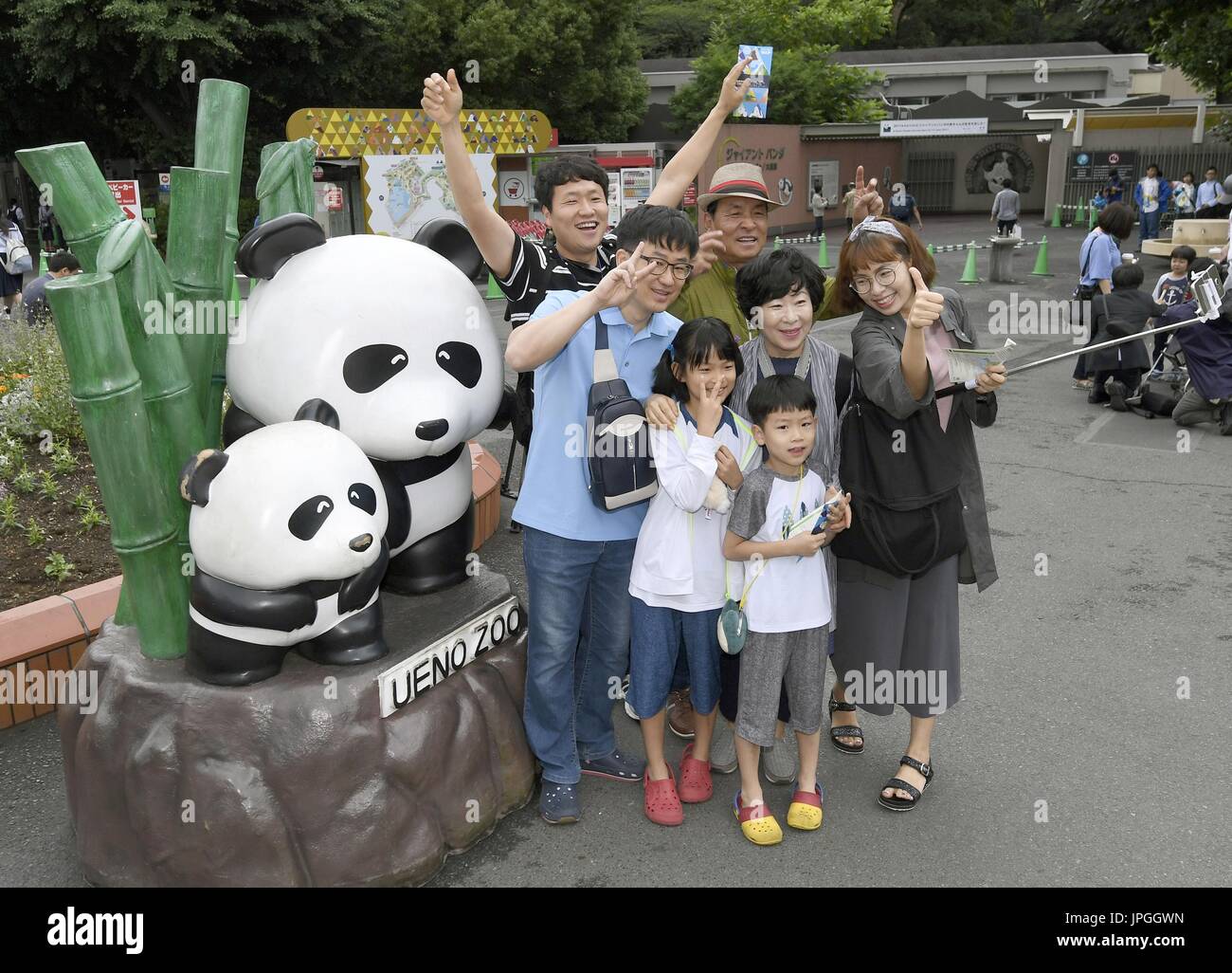 Visitors to Tokyo's Ueno Zoological Gardens pose for photos on June 13 ...