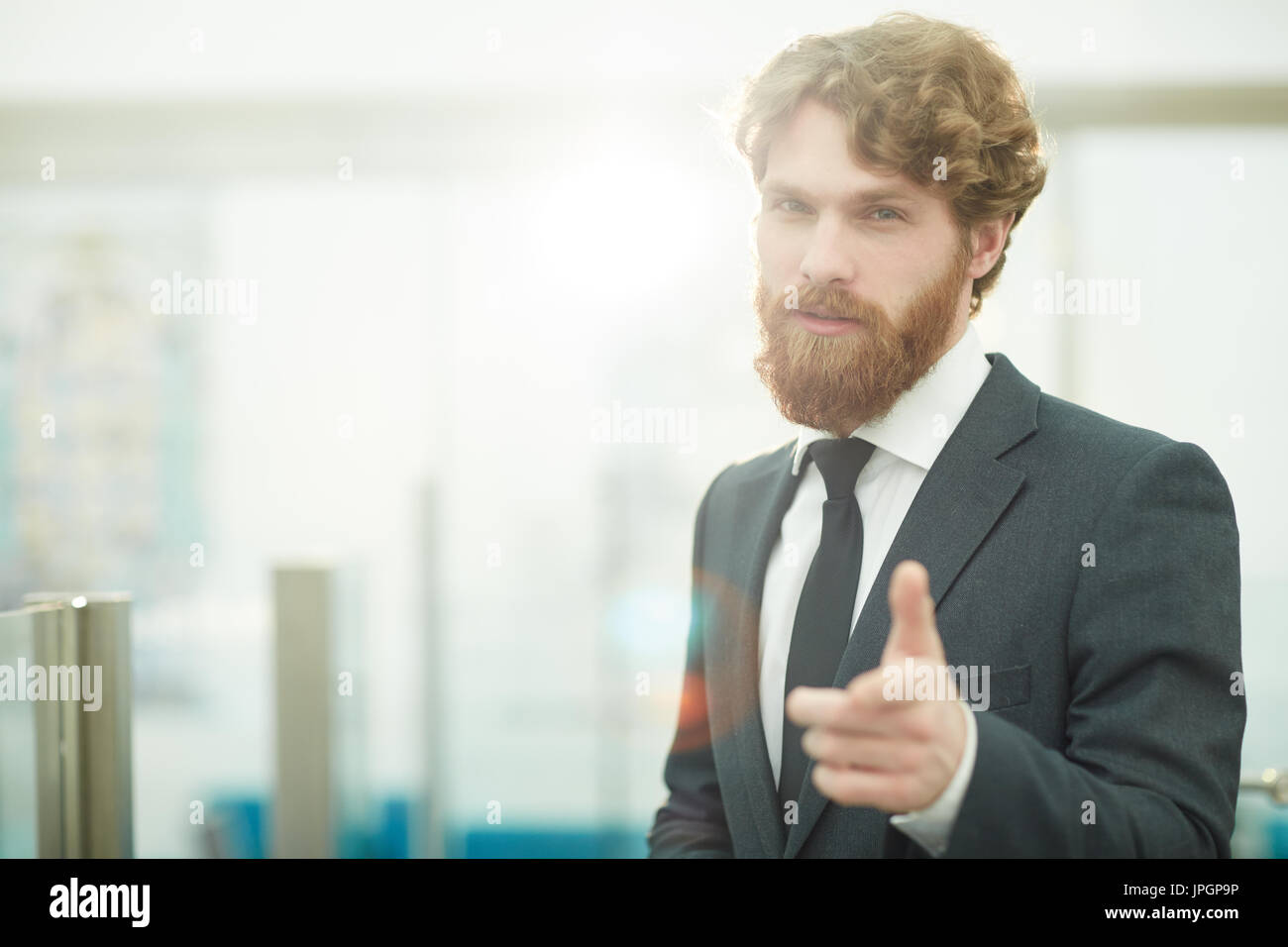 Businessman pointing winking hi-res stock photography and images - Alamy