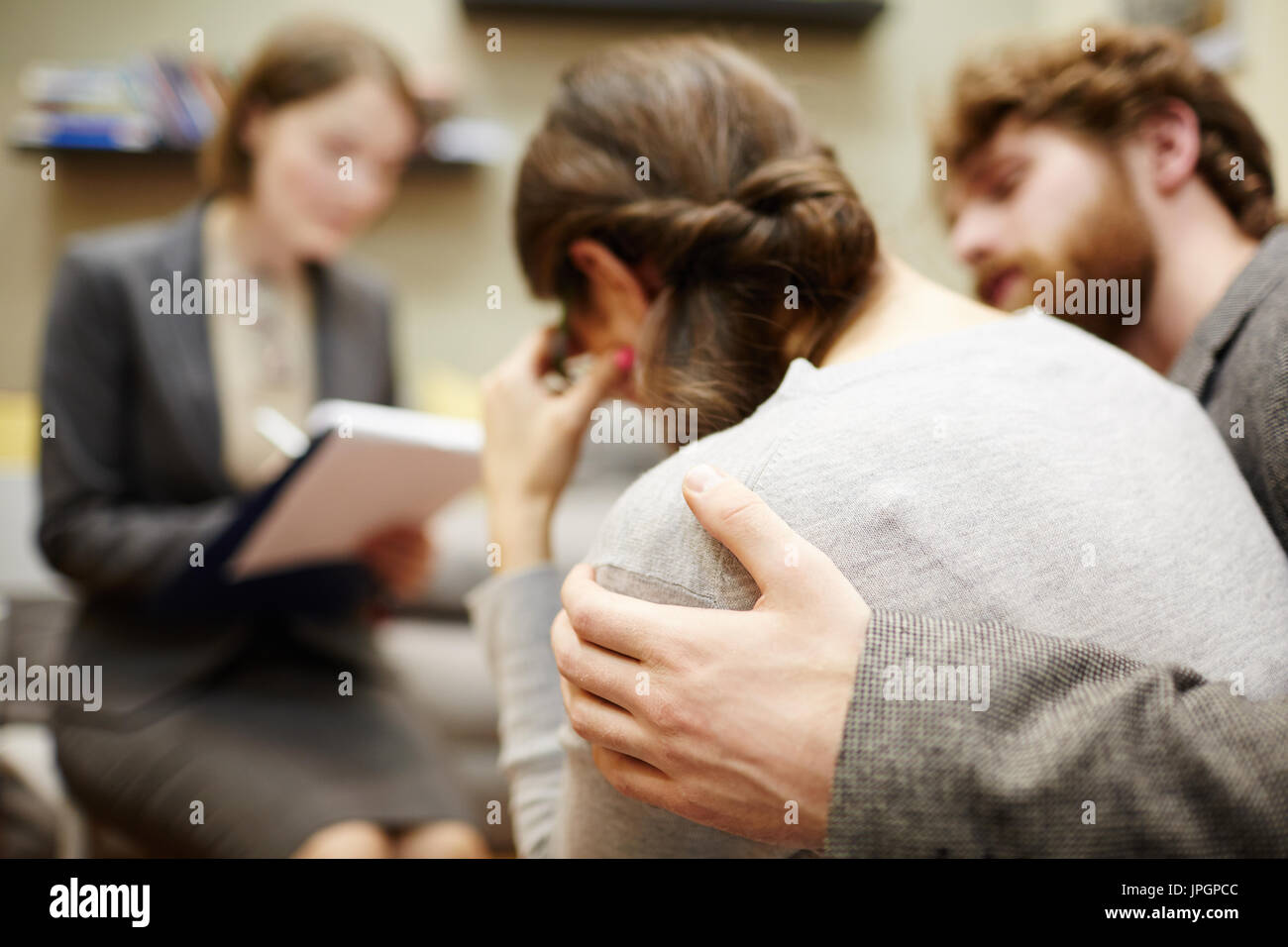 Back view image of young woman crying in couples counseling session ...