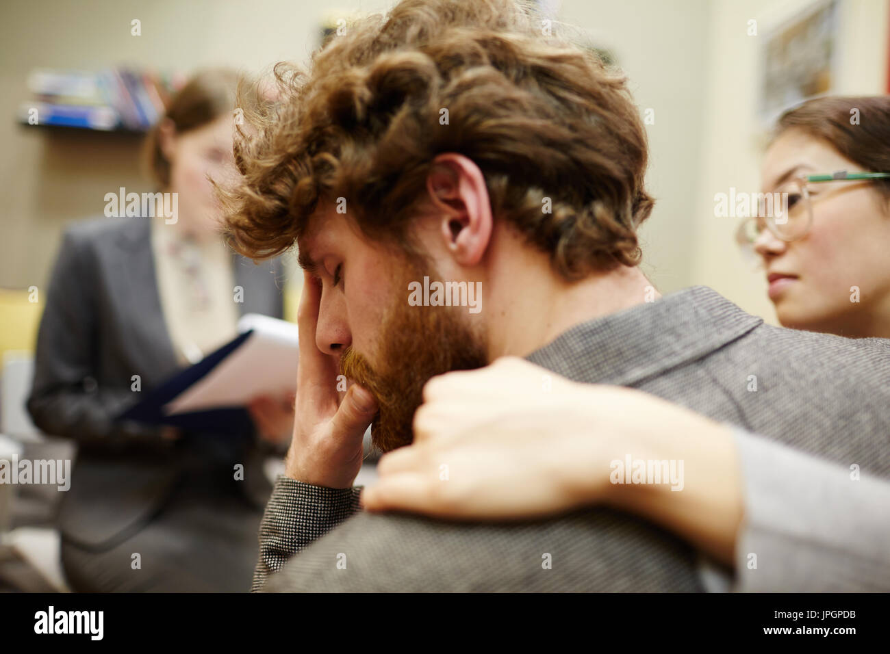 Man and wife hugging sad hi-res stock photography and images - Alamy