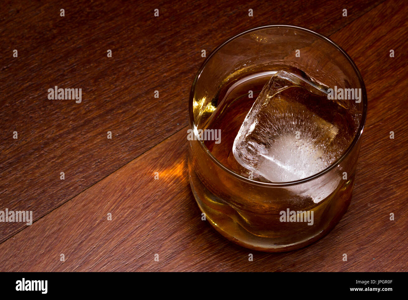blended scotch whiskey served in a short glass with a large ice cube ...