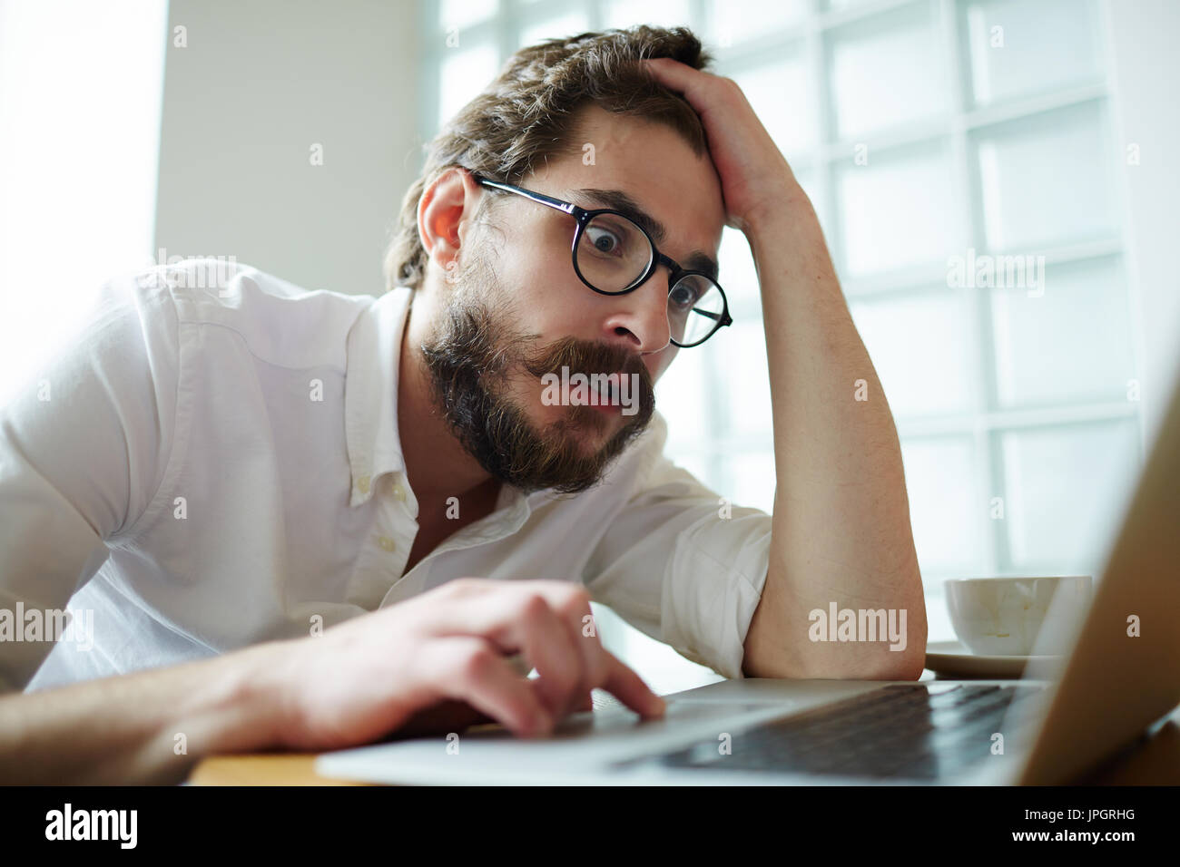 Nervous job-seeker sitting in front of laptop Stock Photo - Alamy