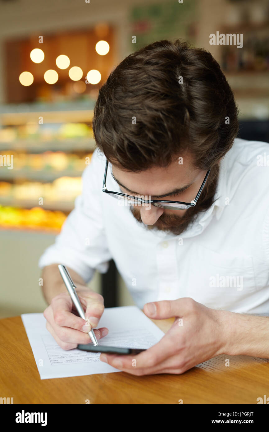 Contemporary man filling in application for vacancy Stock Photo - Alamy