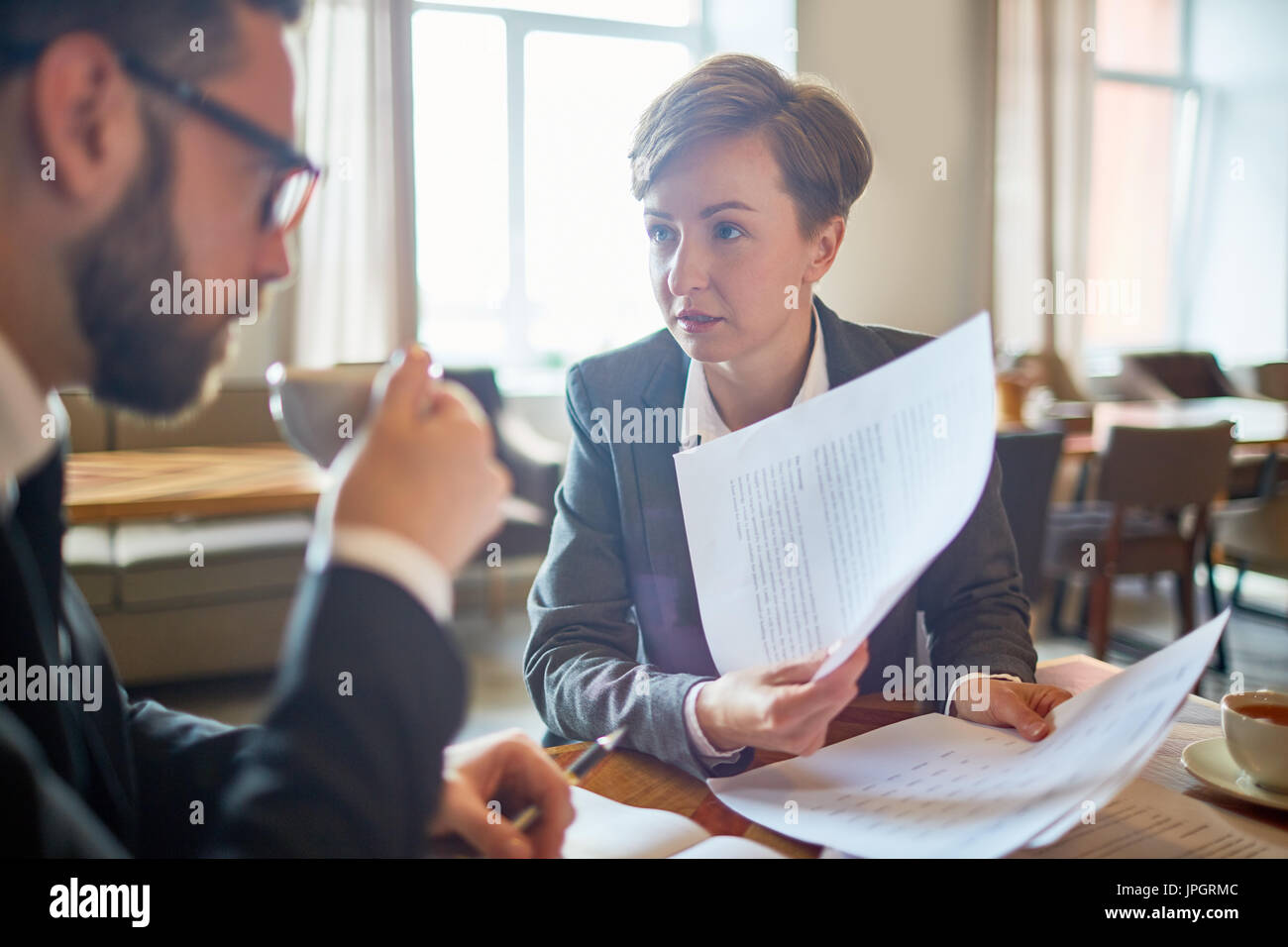 Business agent showing colleague hi-res stock photography and images ...
