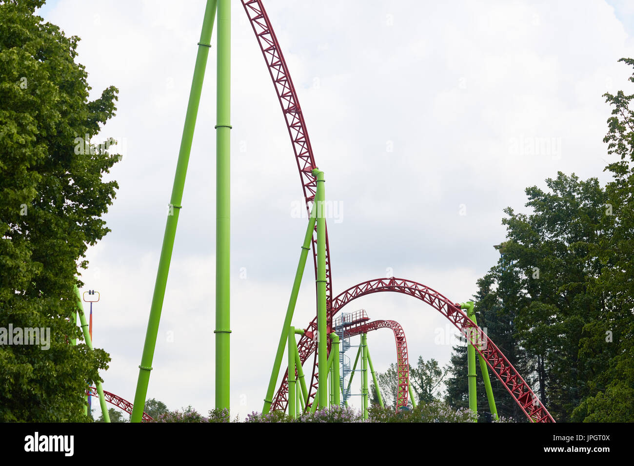 Wide shot image of tall rollercoaster ride in amusement park with no ...