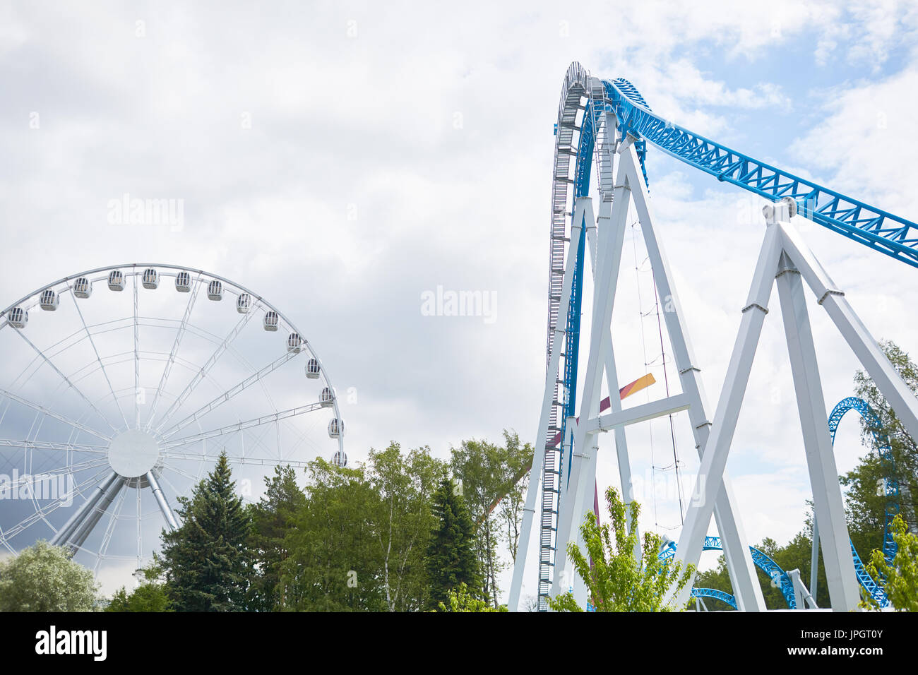 Wide shot image of rides in amusement park, tall Ferris wheel and ...