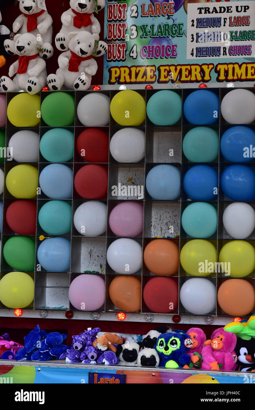 Balloon game on a carnival midway Stock Photo - Alamy