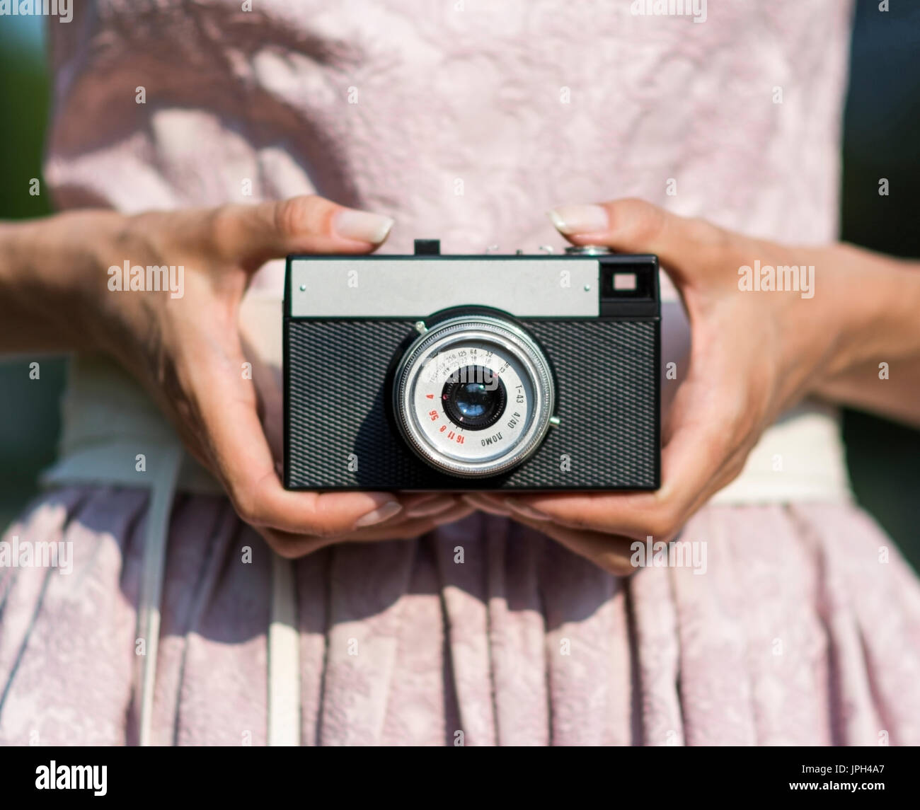 Beautiful brunette girl holding camera hi-res stock photography and ...