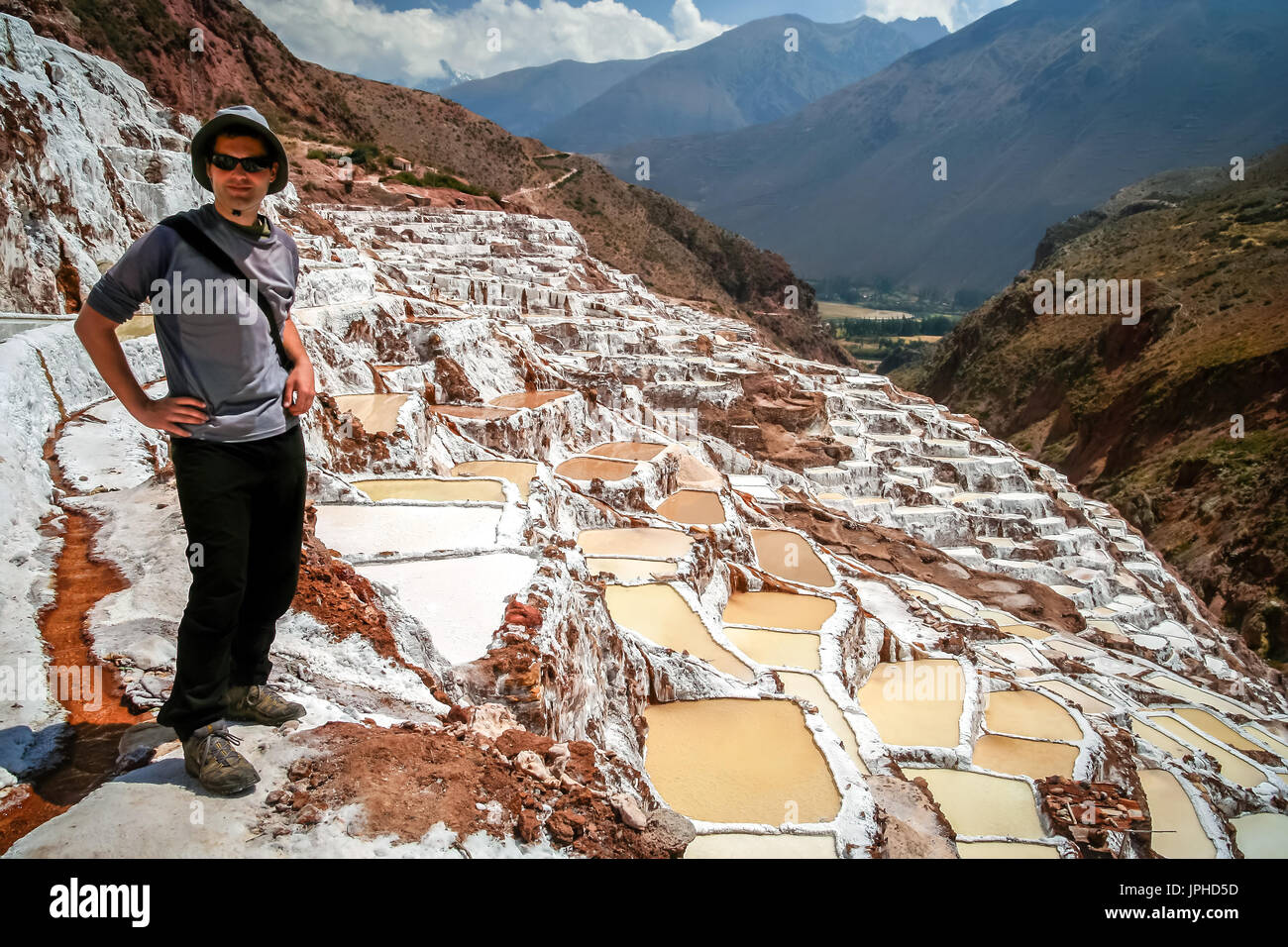 Tourists admiring the traditional salt mine salinas in Maras, Peru ...