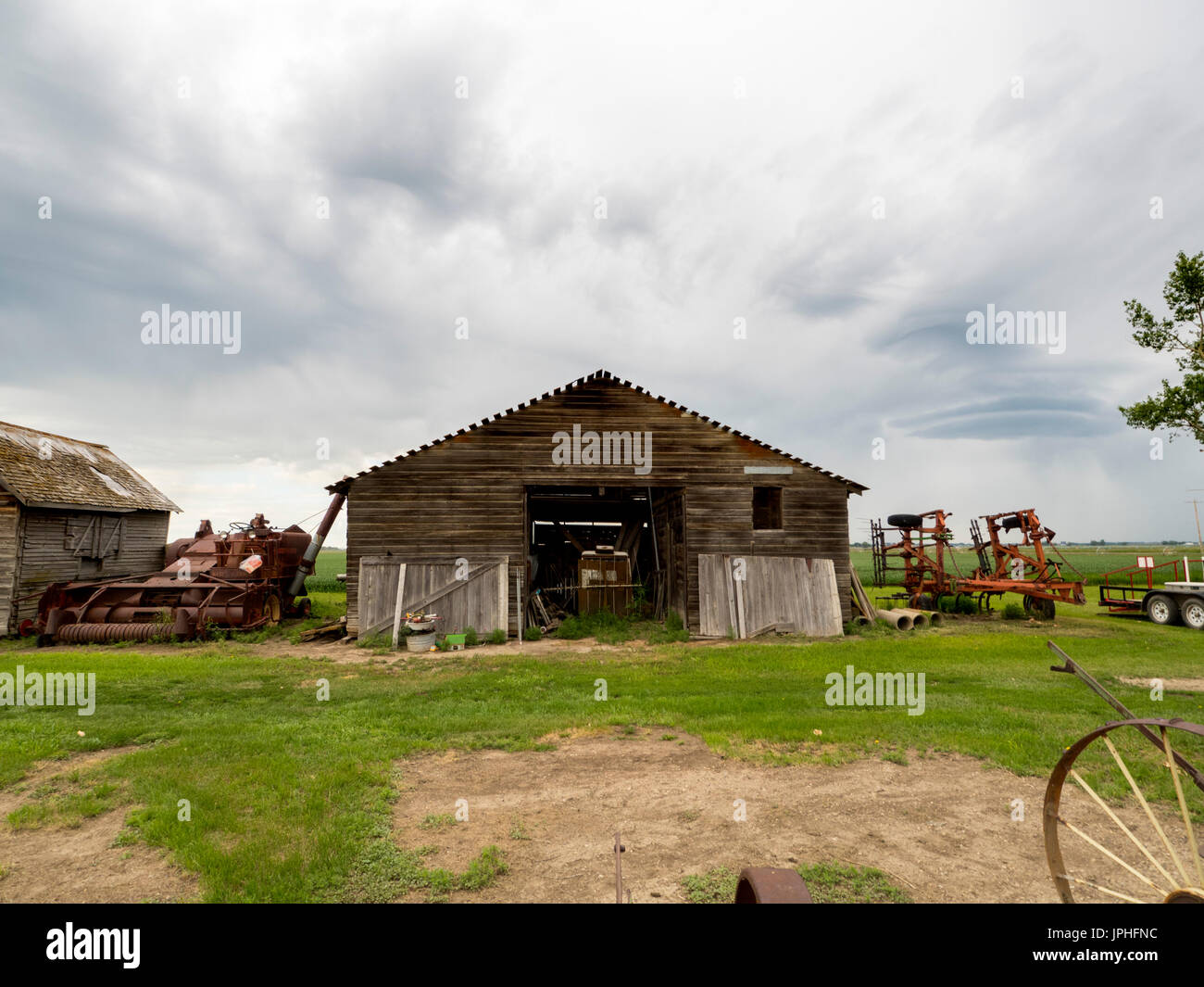 Farm storage house, with vivid rain skies background Stock Photo - Alamy