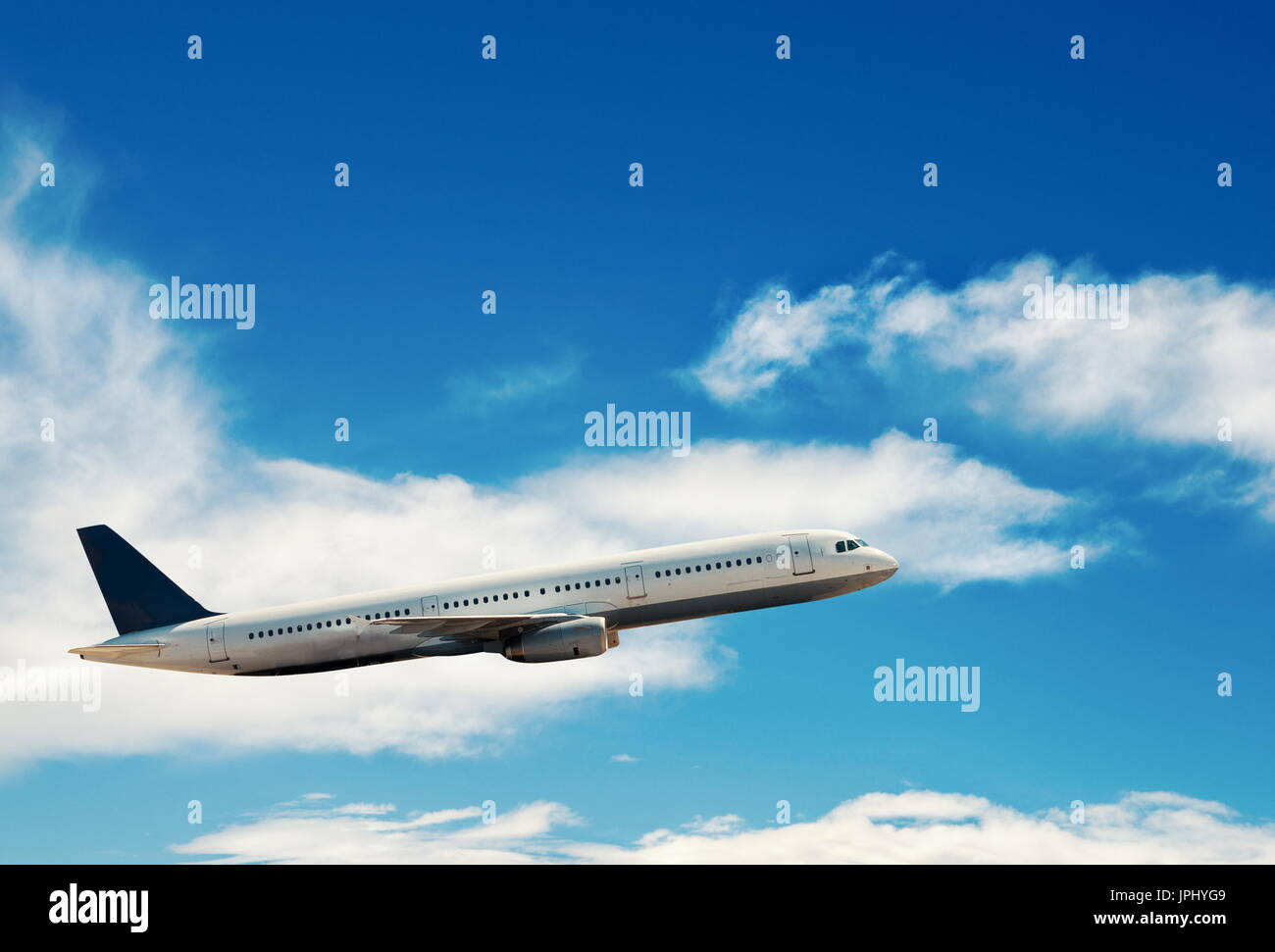 airplane in the blue sky Stock Photo - Alamy