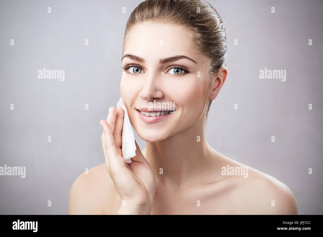 Young woman cleaning her face by napkins Stock Photo - Alamy