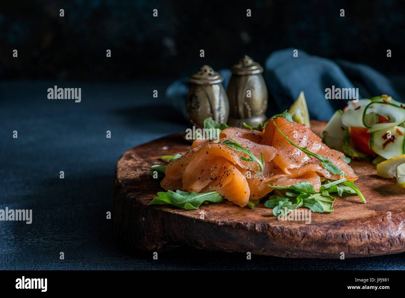 Smoked salmon with cucumber and tomato salad. Cured, salted salmon ...