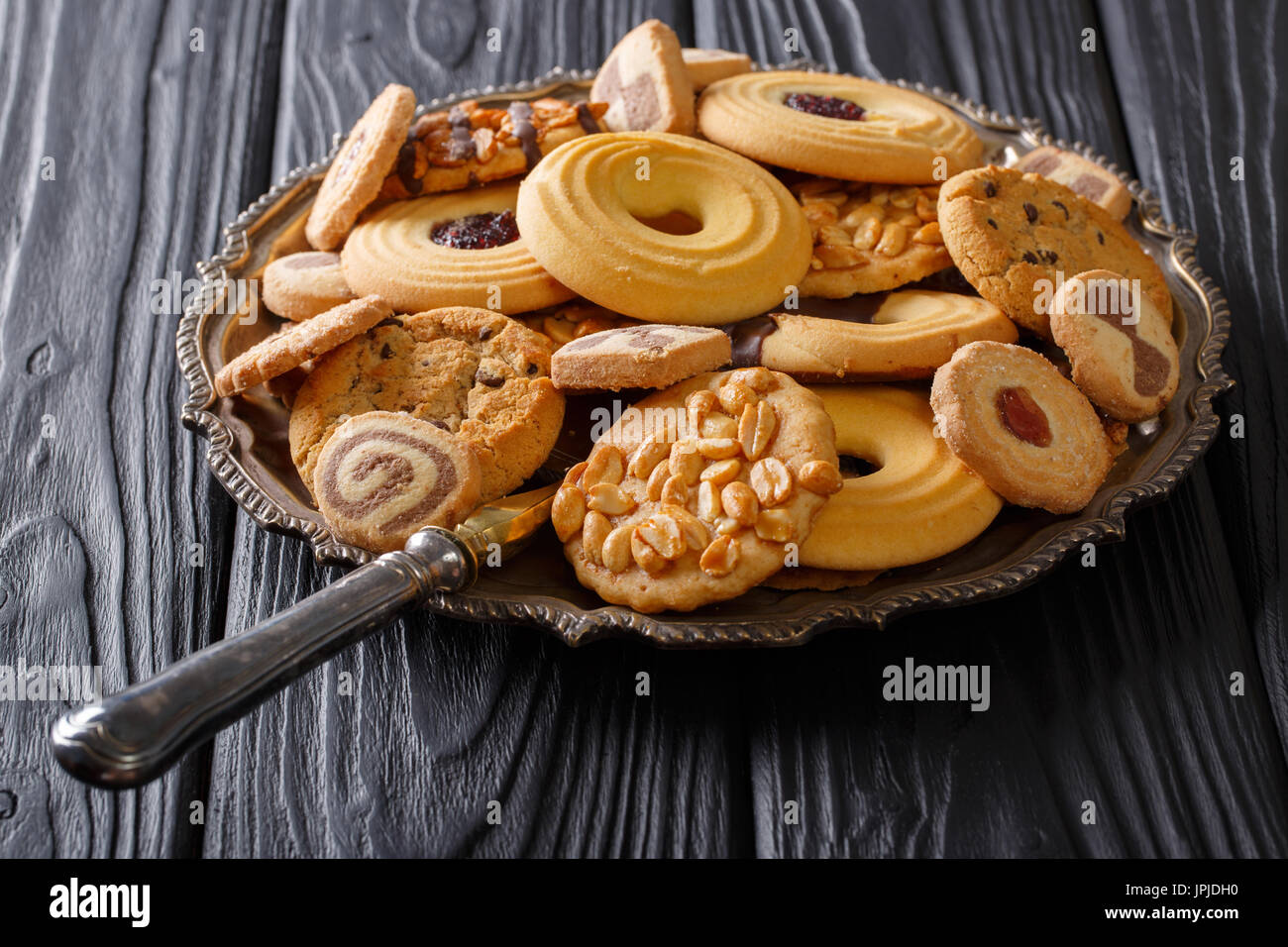 Freshly baked mix of biscuits close-up on a plate on a table ...