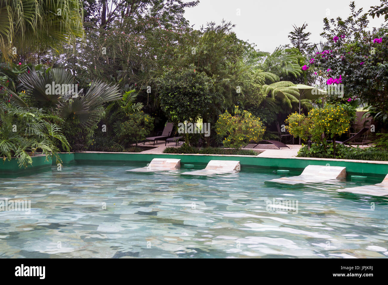 relaxing hot mineral pools in La Fortuna Costa Rica with green tropical ...