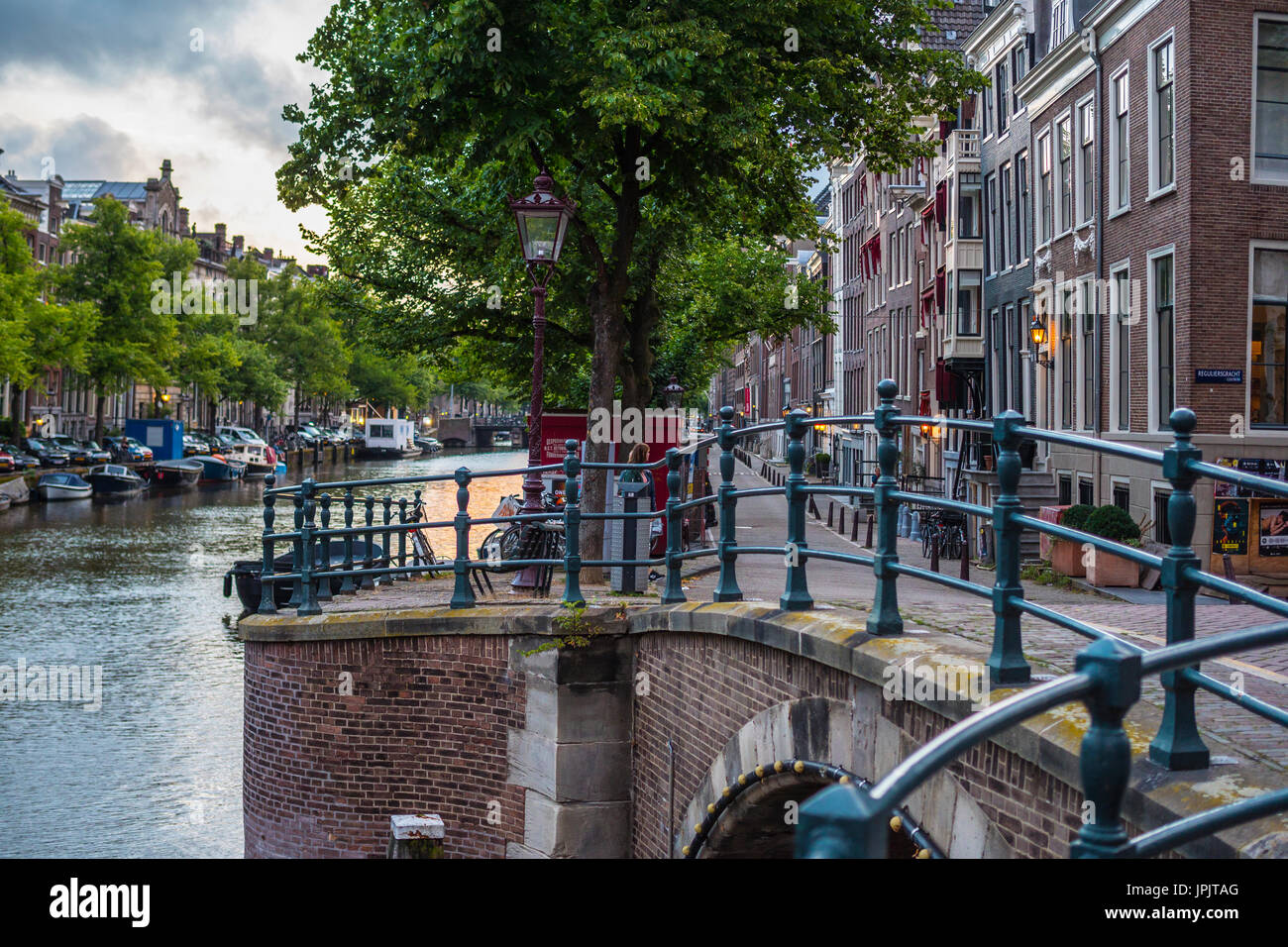 The sidewalks along the canals in the city center of Amsterdam ...