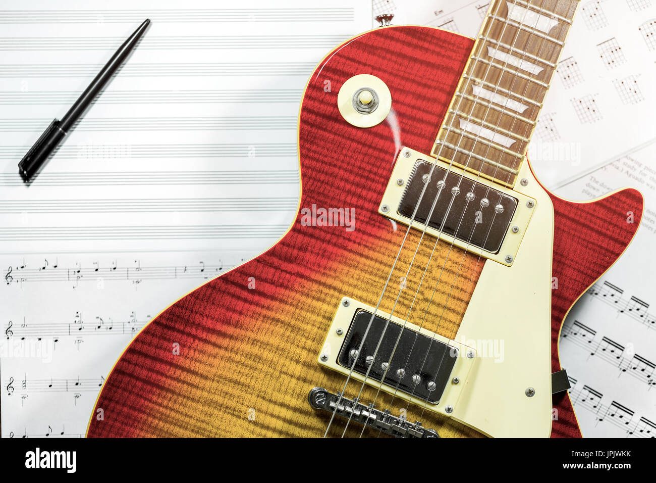 Electric guitar with music notes in the background Stock Photo - Alamy