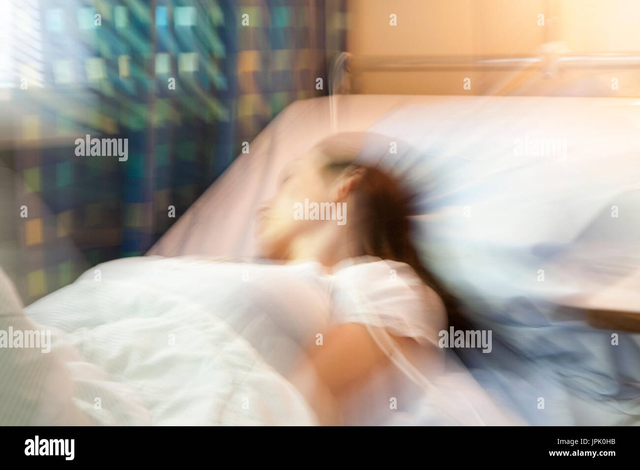 Zoom blur effect of sick woman on iv drip in hospital Model Release ...