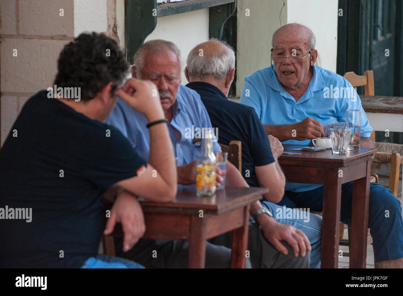 Old Greek men in a taverna at dusk in Crete Stock Photo - Alamy