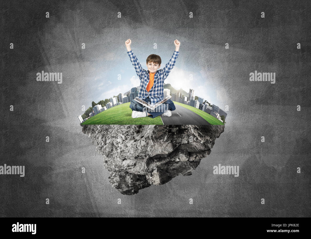 Cute boy of school age with book exploring this great world Stock Photo ...