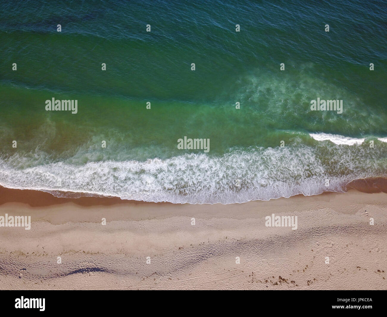 Waves from the Atlantic Ocean wash onto a scenic beach on Cape Cod ...