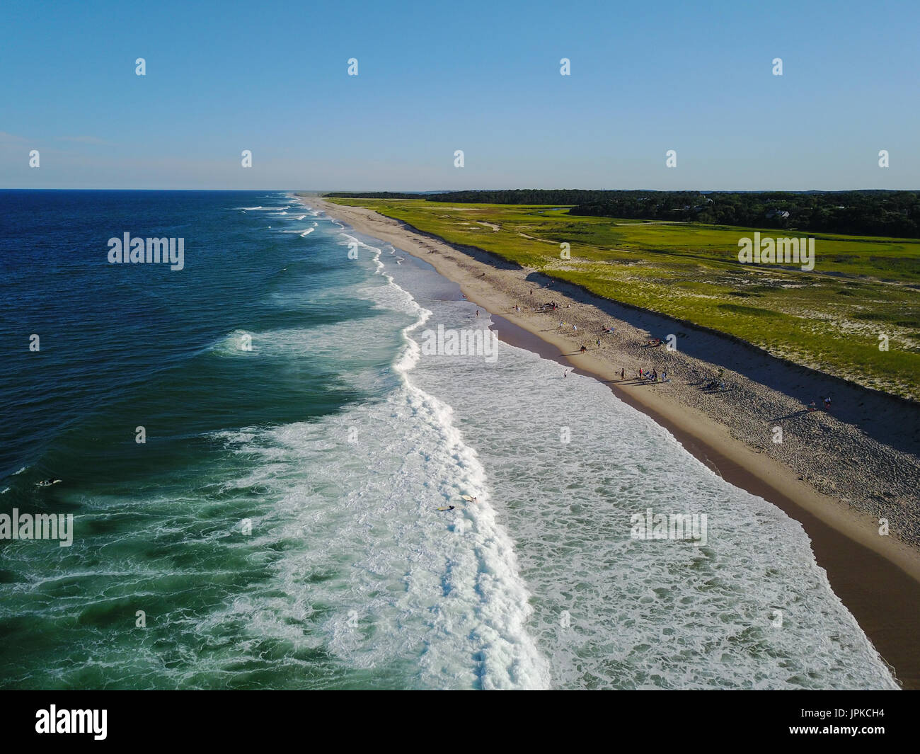 Waves from the Atlantic Ocean wash onto a scenic beach on Cape Cod ...