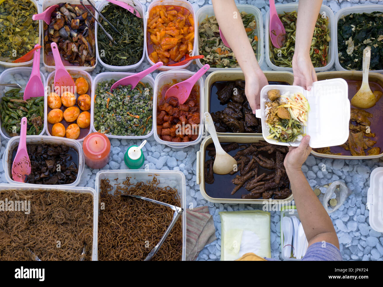 Top view of unidentified vendor and customer at the food stall in Kota ...