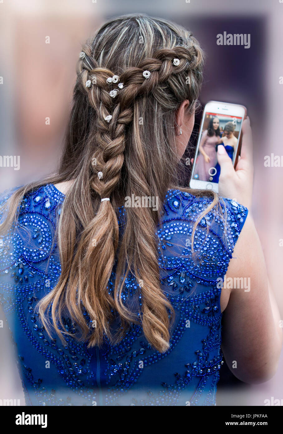 Teenage girls attending the high school prom all dressed up in ...