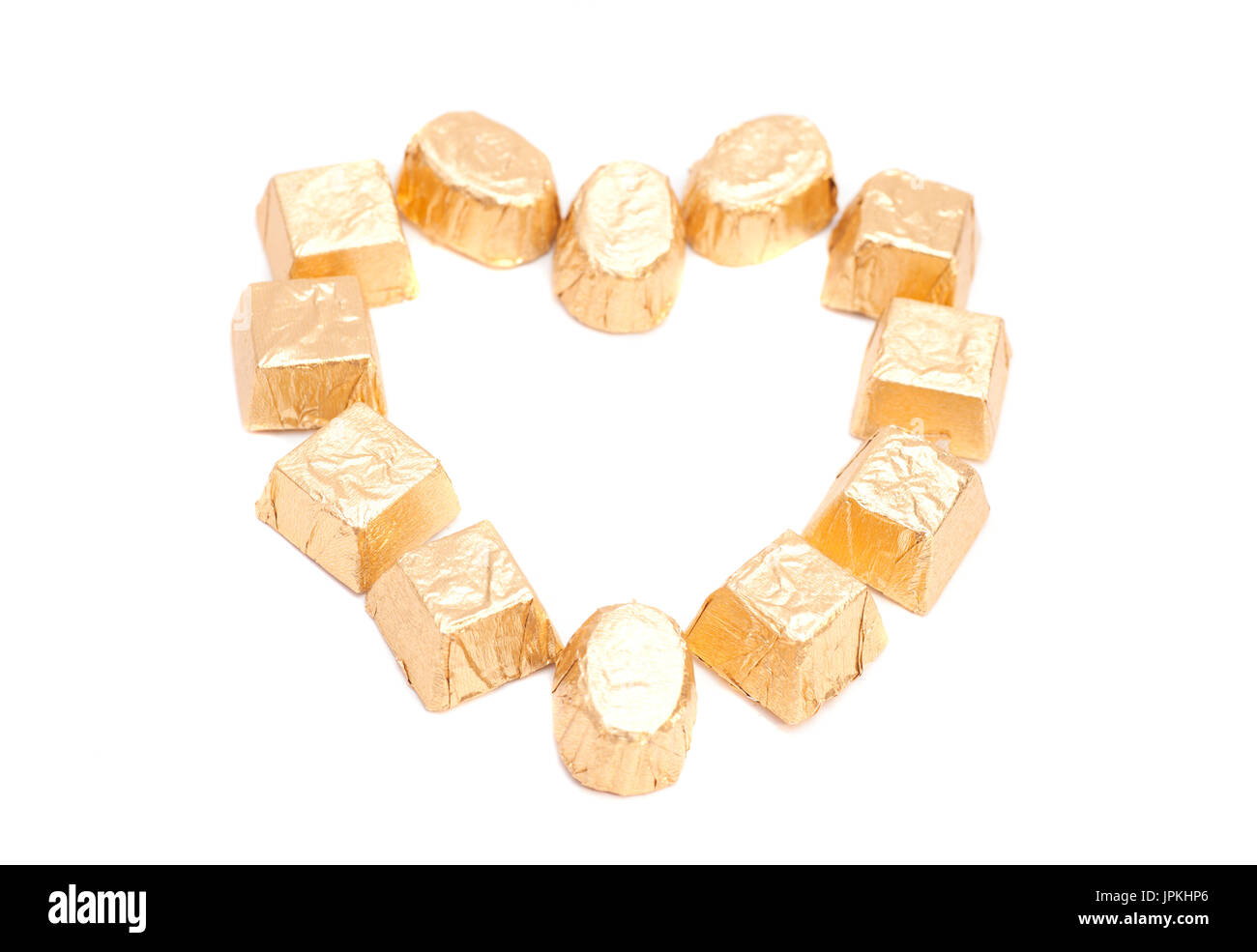 Chocolate candies in gold foil paper forming the heart shape Stock ...