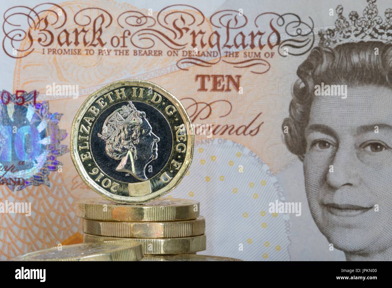 The new 12 sided one pound coin with a ten pound note in the background ...