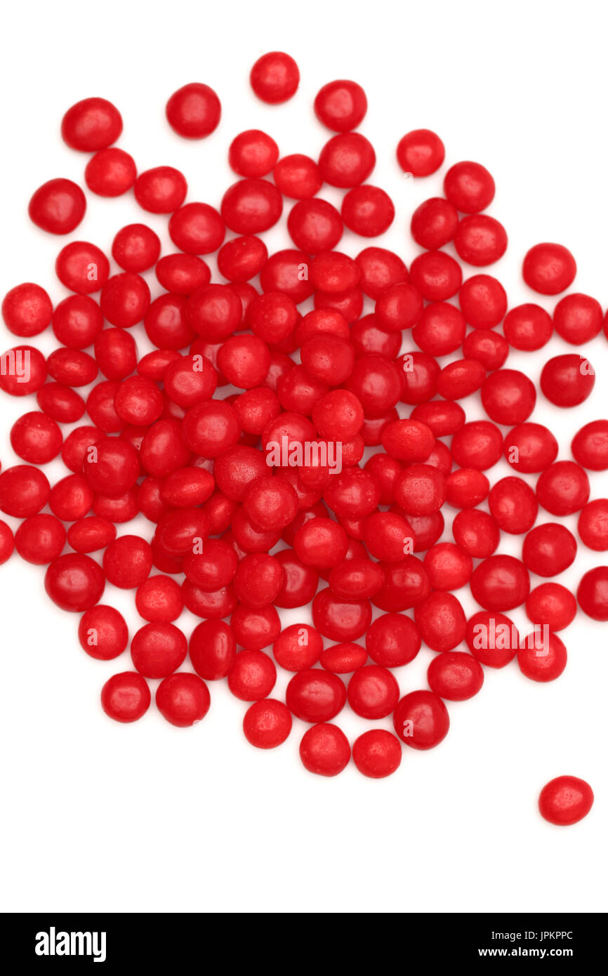 Round red cinnamon candy isolated on a white background Stock Photo - Alamy