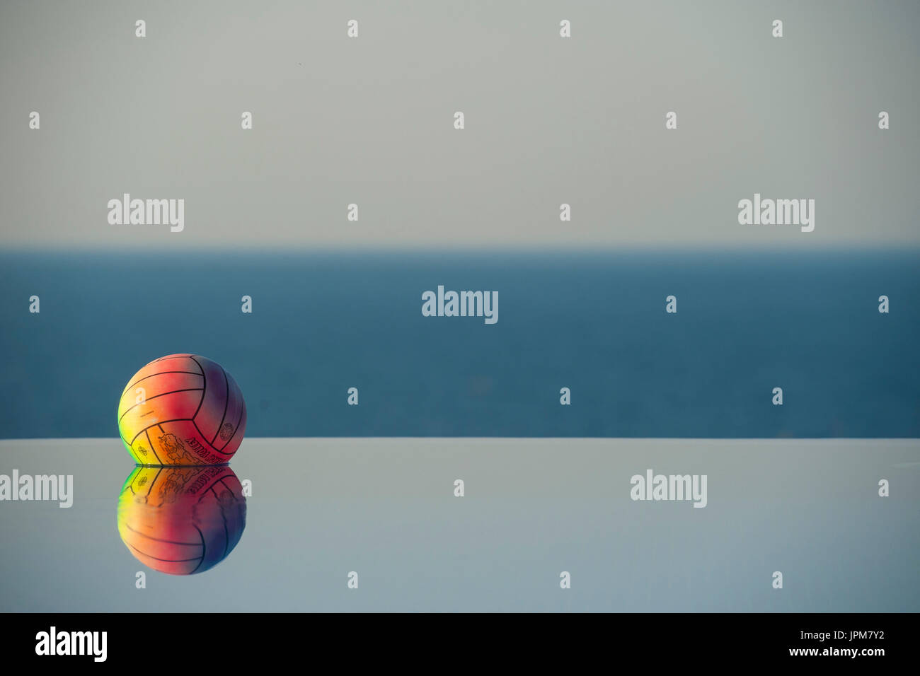 A multicoloured ball floats on an infinity pool Stock Photo - Alamy