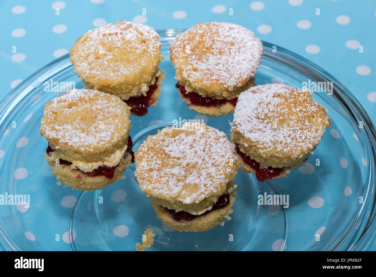 Mini Victoria Sponge cakes on a glass plate Stock Photo - Alamy