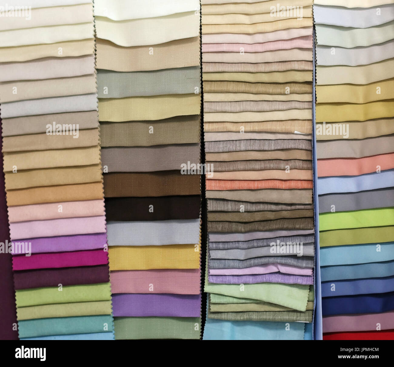 Colorful materials samples hanging on display wall Stock Photo - Alamy