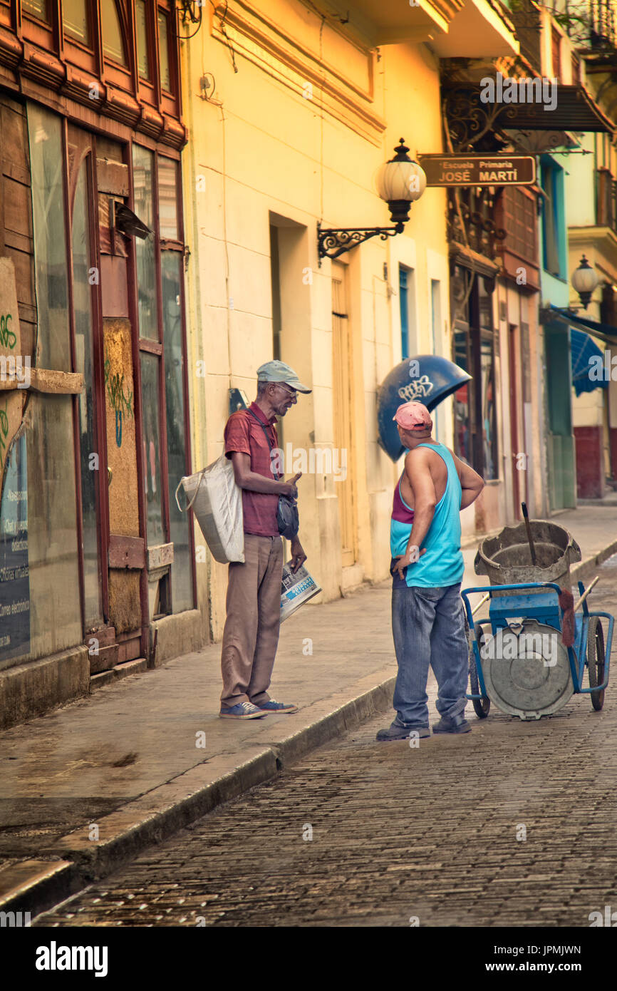 Two men standing on city street talking in Havana, Cuba Stock Photo - Alamy