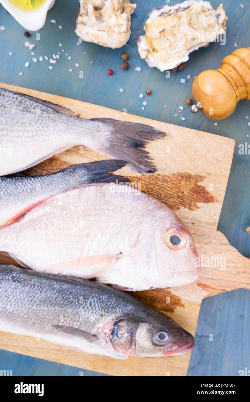 fresh sea fish preparation - dorada and seabass choise of fresh fish on ...