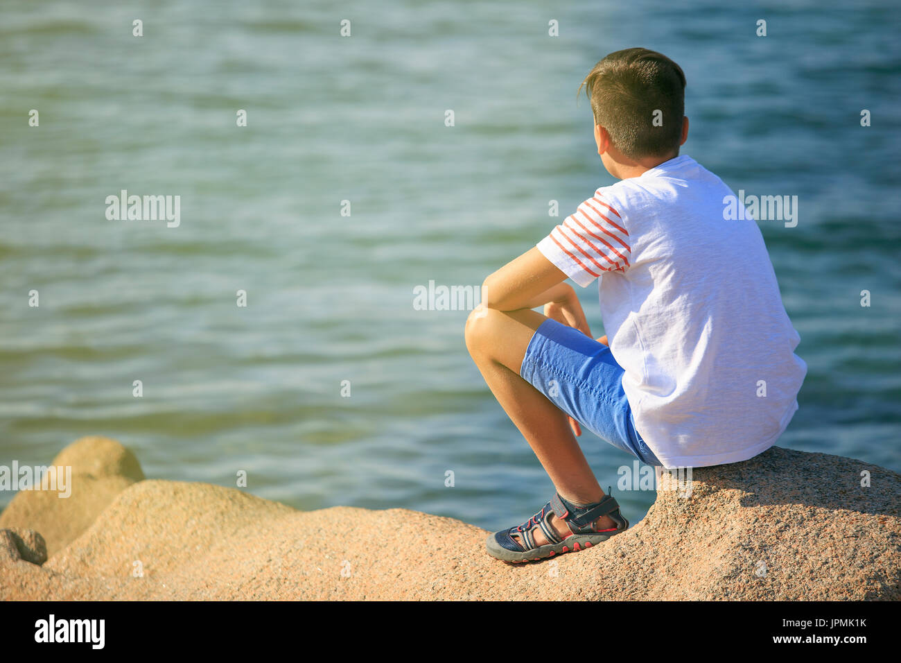 Lonely Single Boy Sitting On Stock Photos & Lonely Single Boy Sitting ...