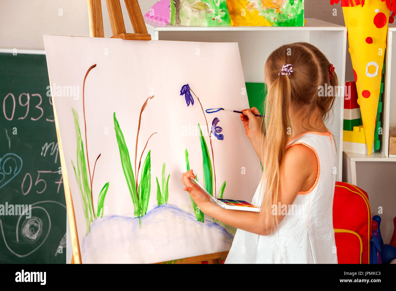Children painting finger on easel. Group of kids with teacher Stock ...