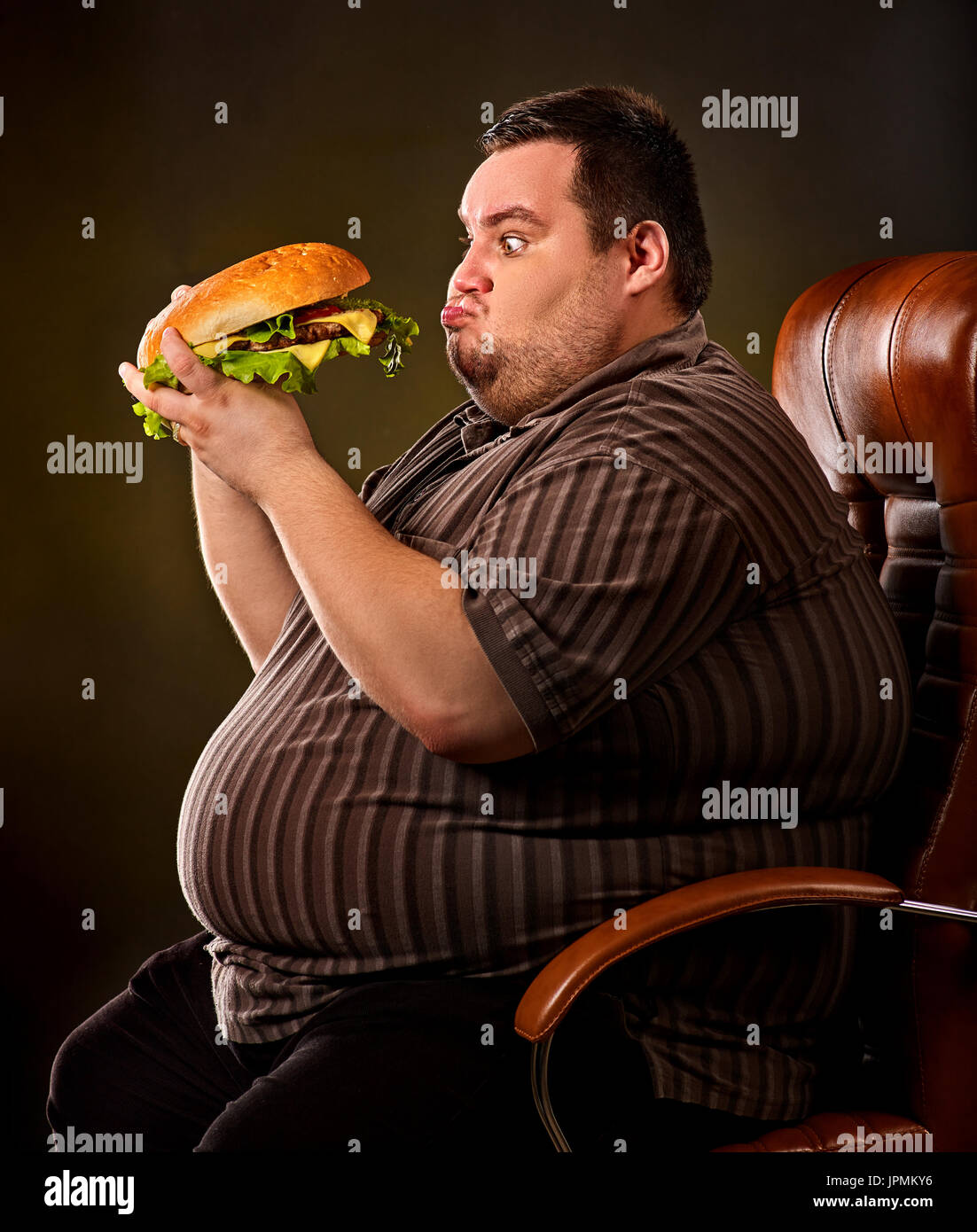 Fat man eating fast food hamberger. Breakfast for overweight person ...
