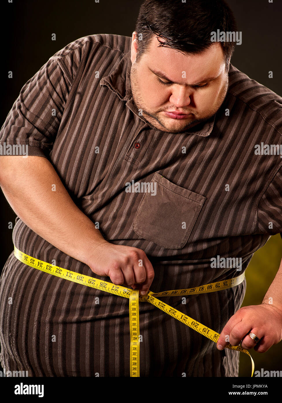 Man belly fat with tape measure weight loss around body Stock Photo - Alamy