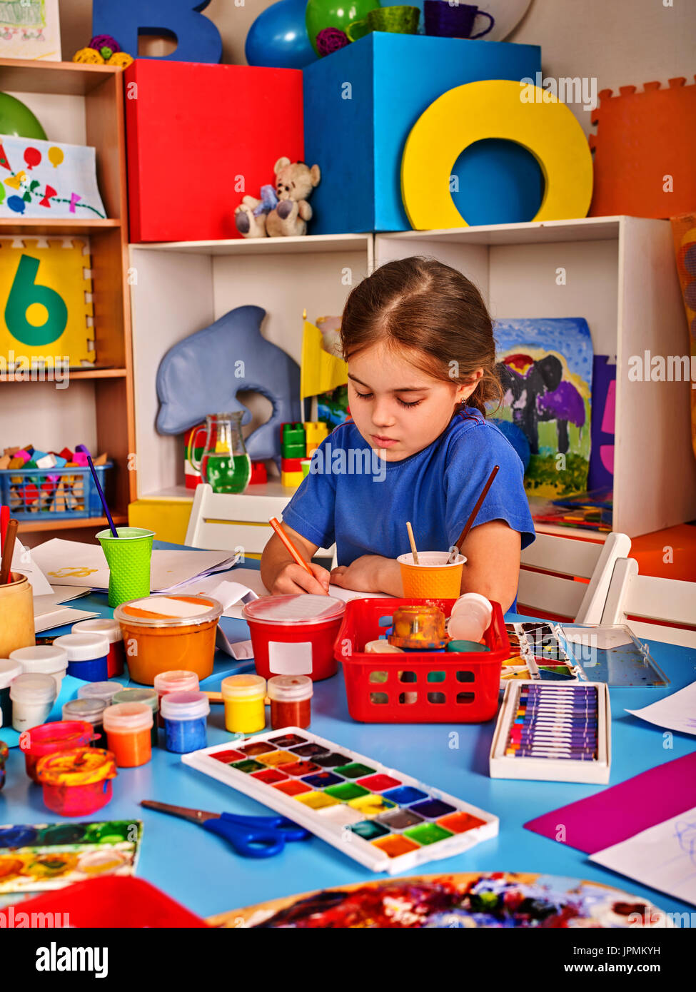 Small students girl painting in art school class Stock Photo - Alamy