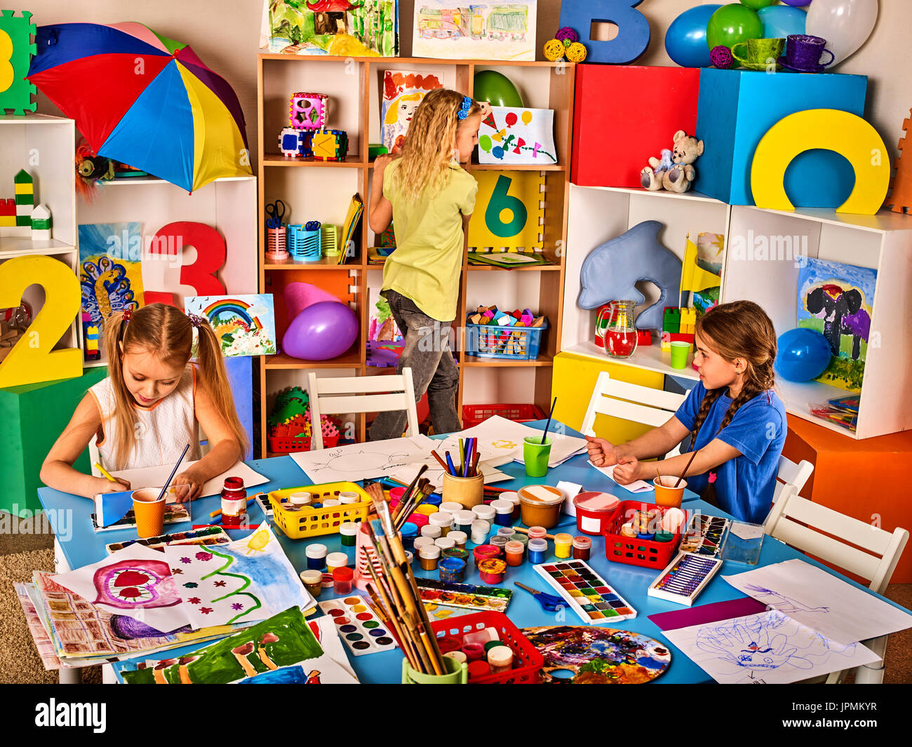 Children painting and drawing together. Craft lesson in primary school ...