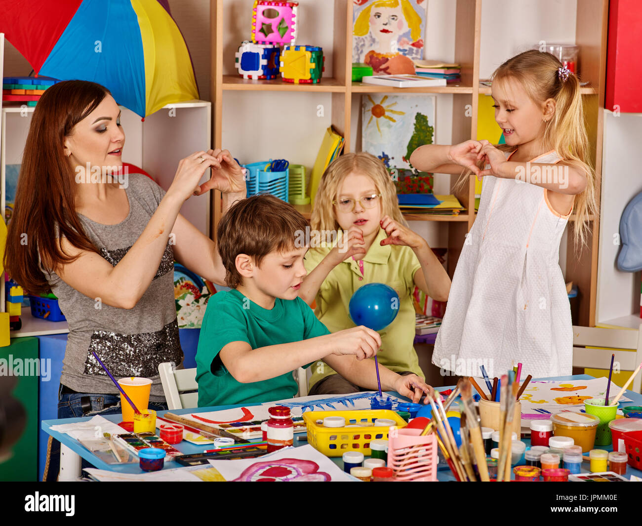 Plasticine modeling clay in children class. Teacher teaches in school ...