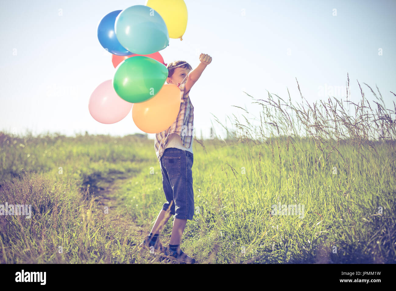 Happy little boy playing on road at the day time. He running in the ...
